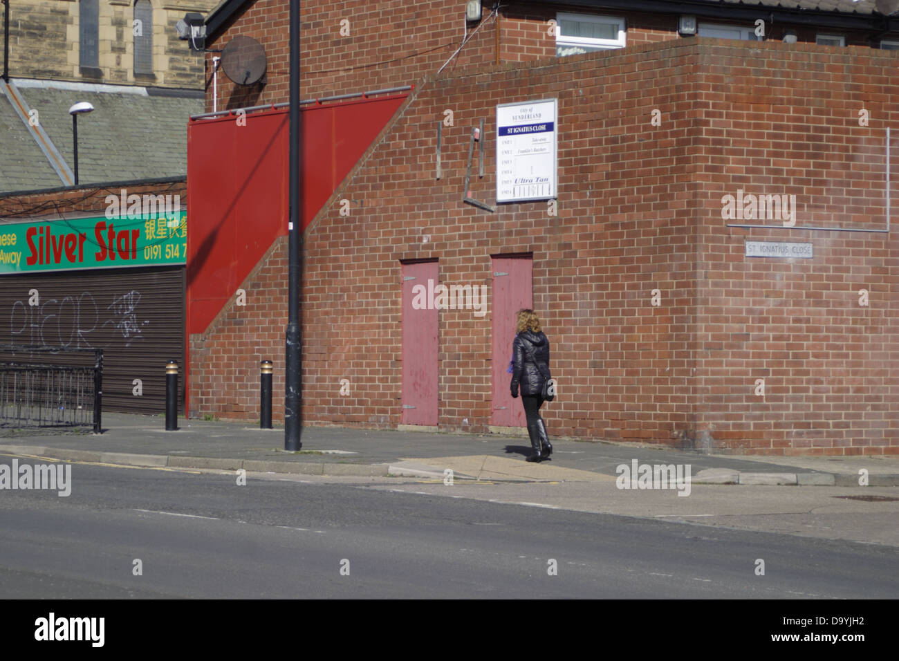 Lady walking down a road in Sunderland Stock Photo - Alamy