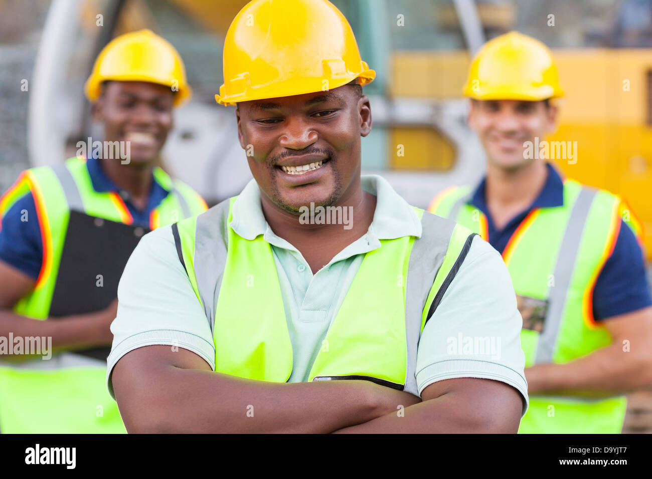 smiling African construction worker with colleagues Stock Photo - Alamy