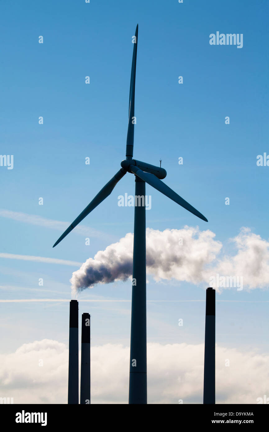 Wind turbine in front powerplant chimneys Stock Photo - Alamy