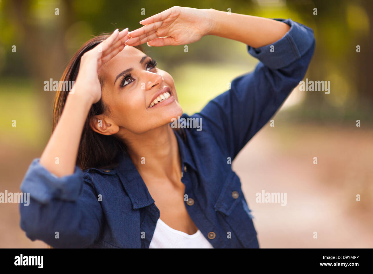 beautiful young woman looking up in the forest Stock Photo - Alamy
