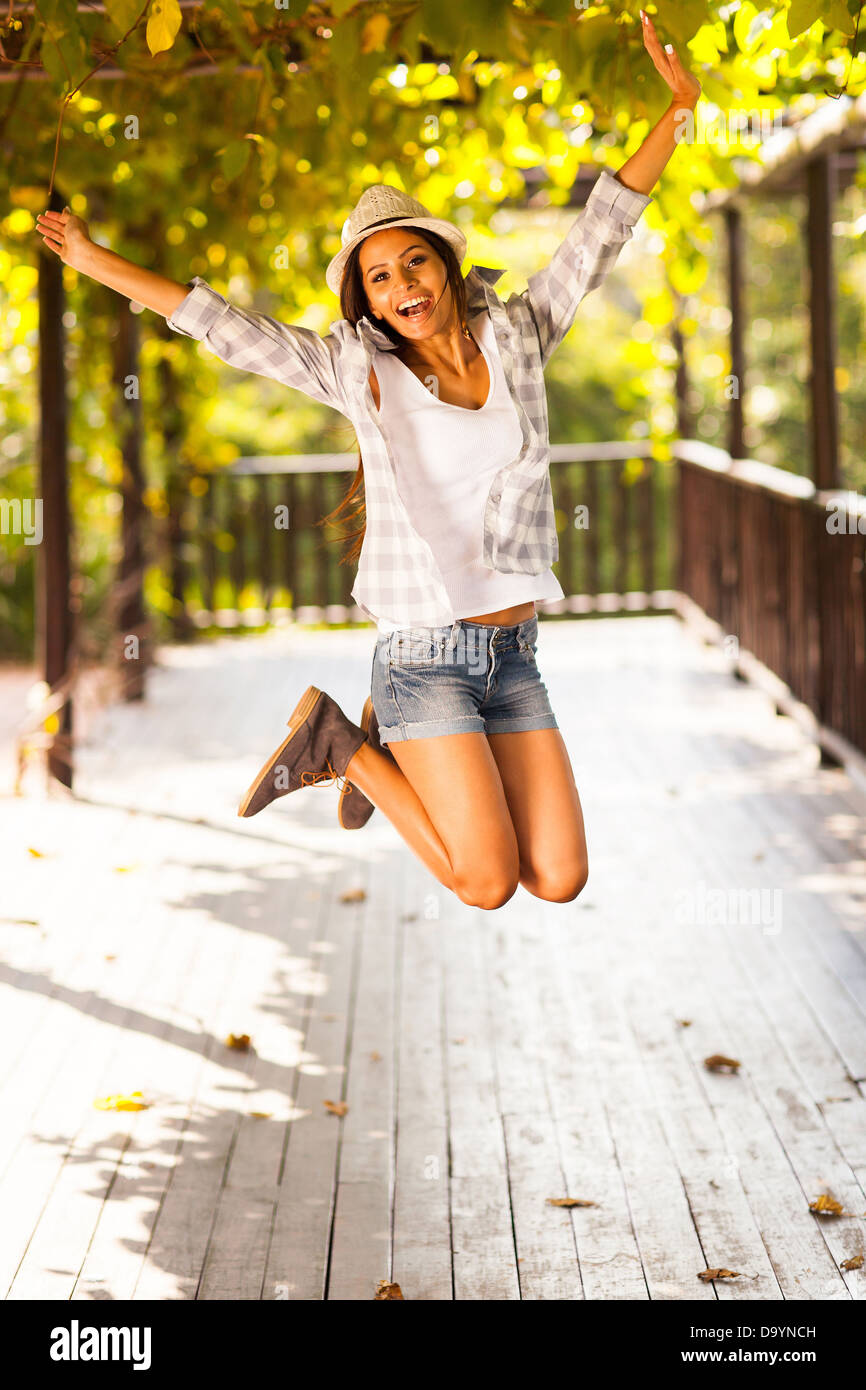 excited young woman jumping outdoors Stock Photo - Alamy