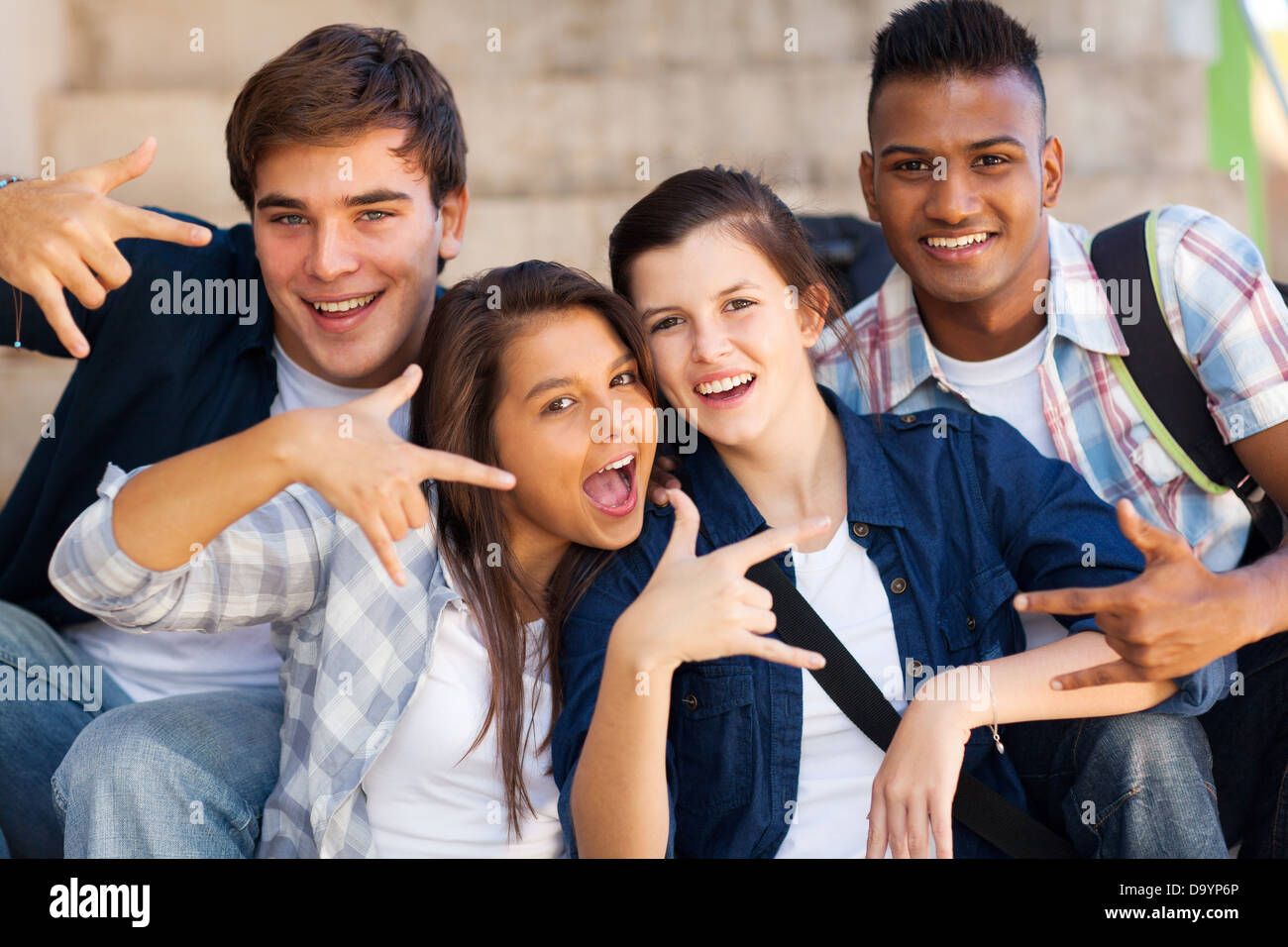 group of happy teenagers giving cool hand signs Stock Photo - Alamy