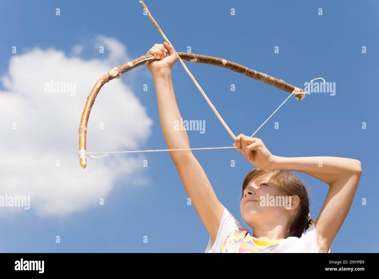Girl is aiming her arrow for the clouds Stock Photo - Alamy
