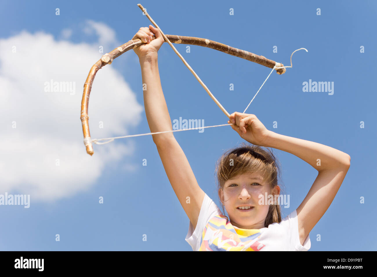 Girl with her bow and arrow aiming at the sky Stock Photo - Alamy