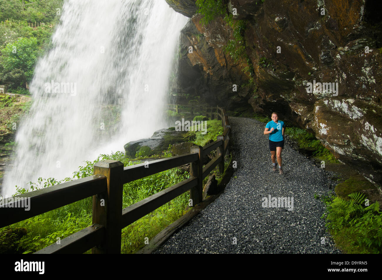 A woman trail running behind Dry Falls Stock Photo - Alamy