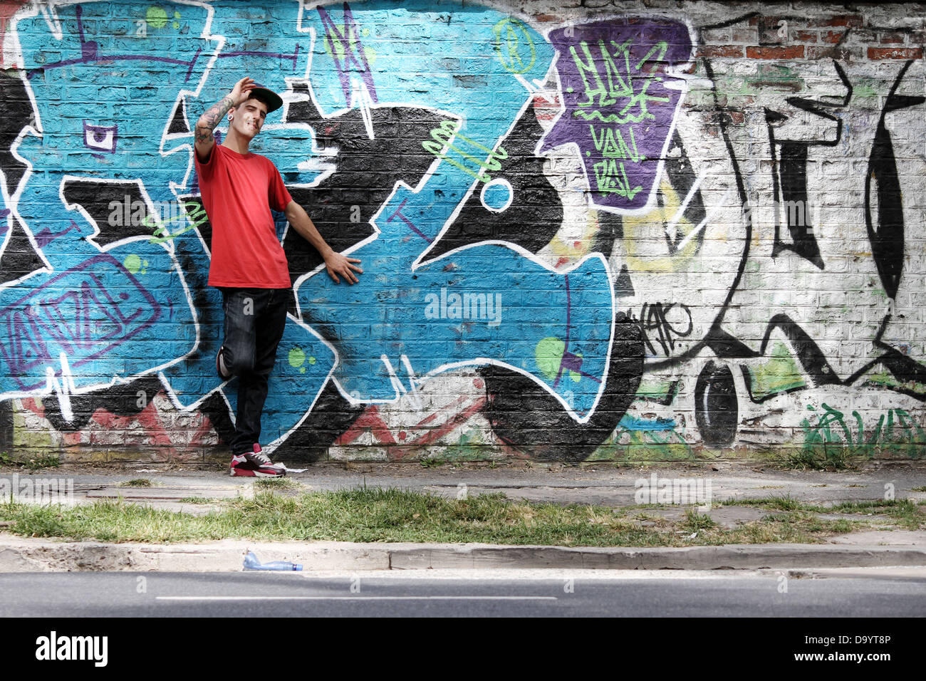 A greeting young Rapper greeting in front of a Graffiti wall Stock ...
