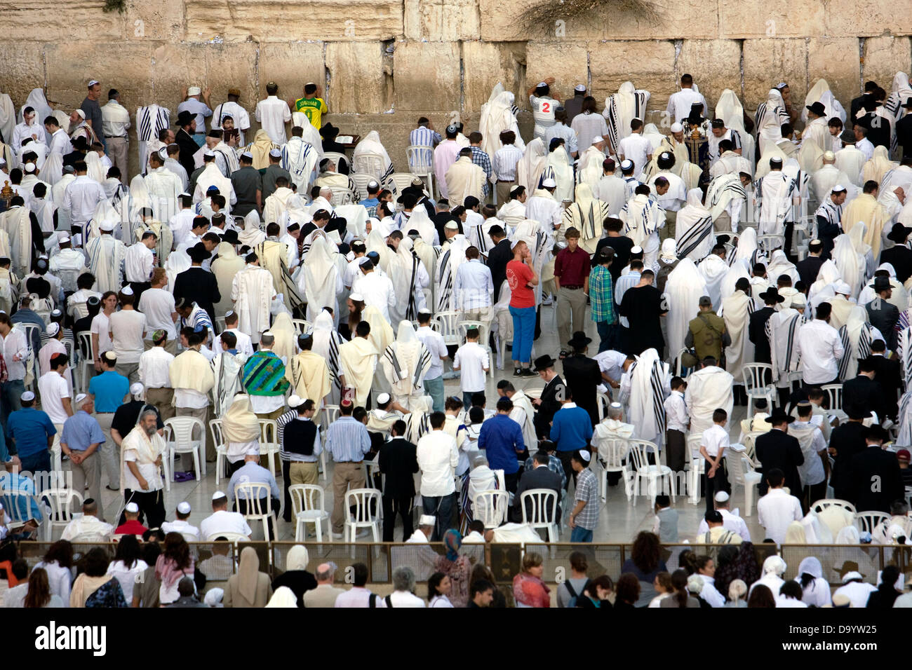 Jewish religious man and woman with traditional clothes pray at the ...