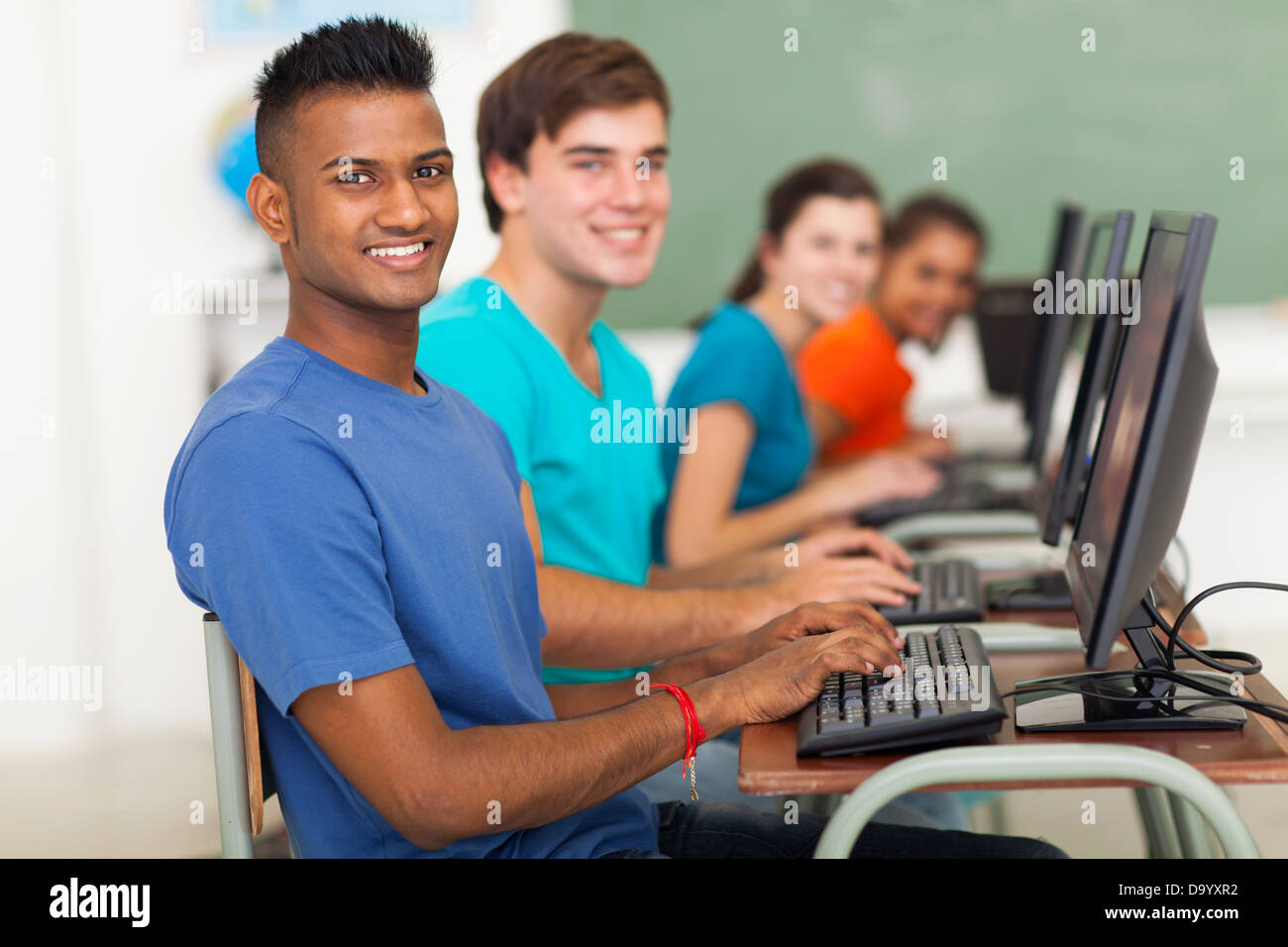 group of diversity high school students using computer in classroom ...
