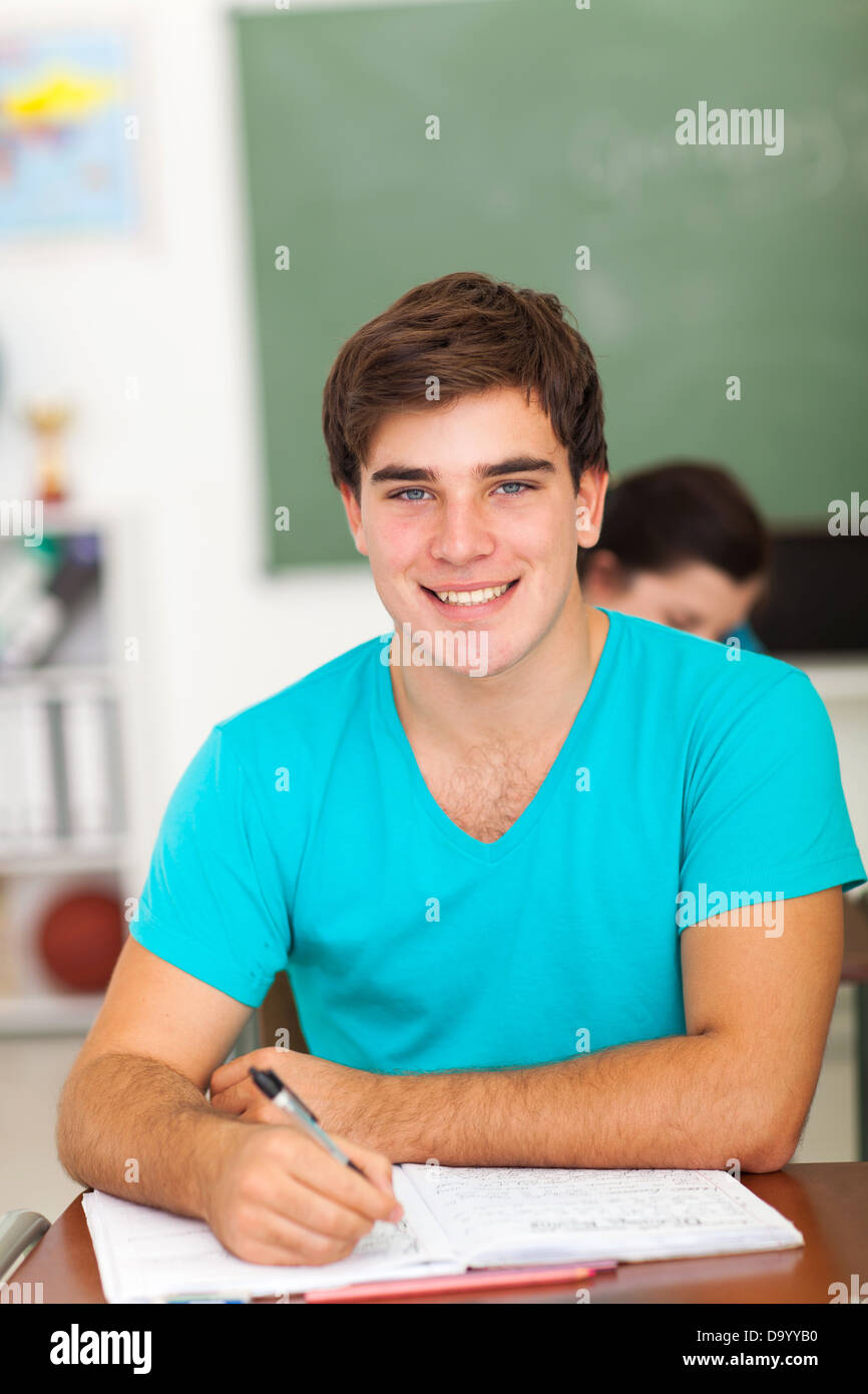 handsome high school student writing classwork Stock Photo - Alamy