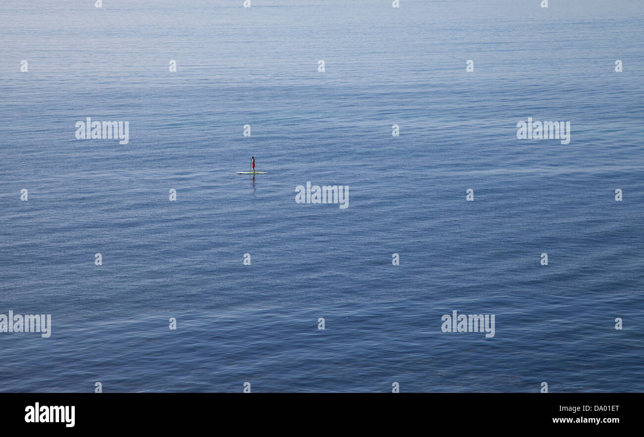 man paddle boarding all alone on ocean Stock Photo - Alamy