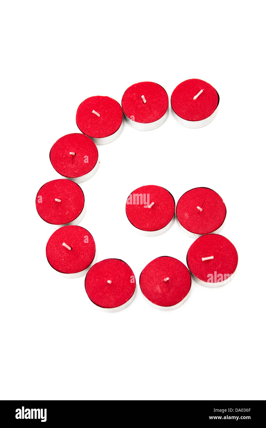 Letter G formed by candles on a white background Stock Photo - Alamy