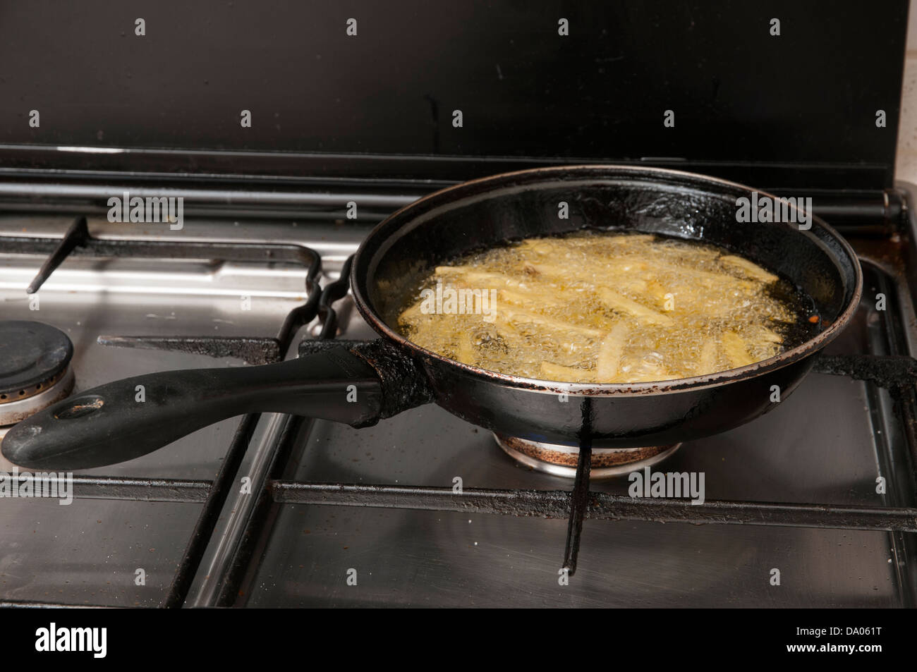 cooking pan fries on the kitchen Stock Photo - Alamy