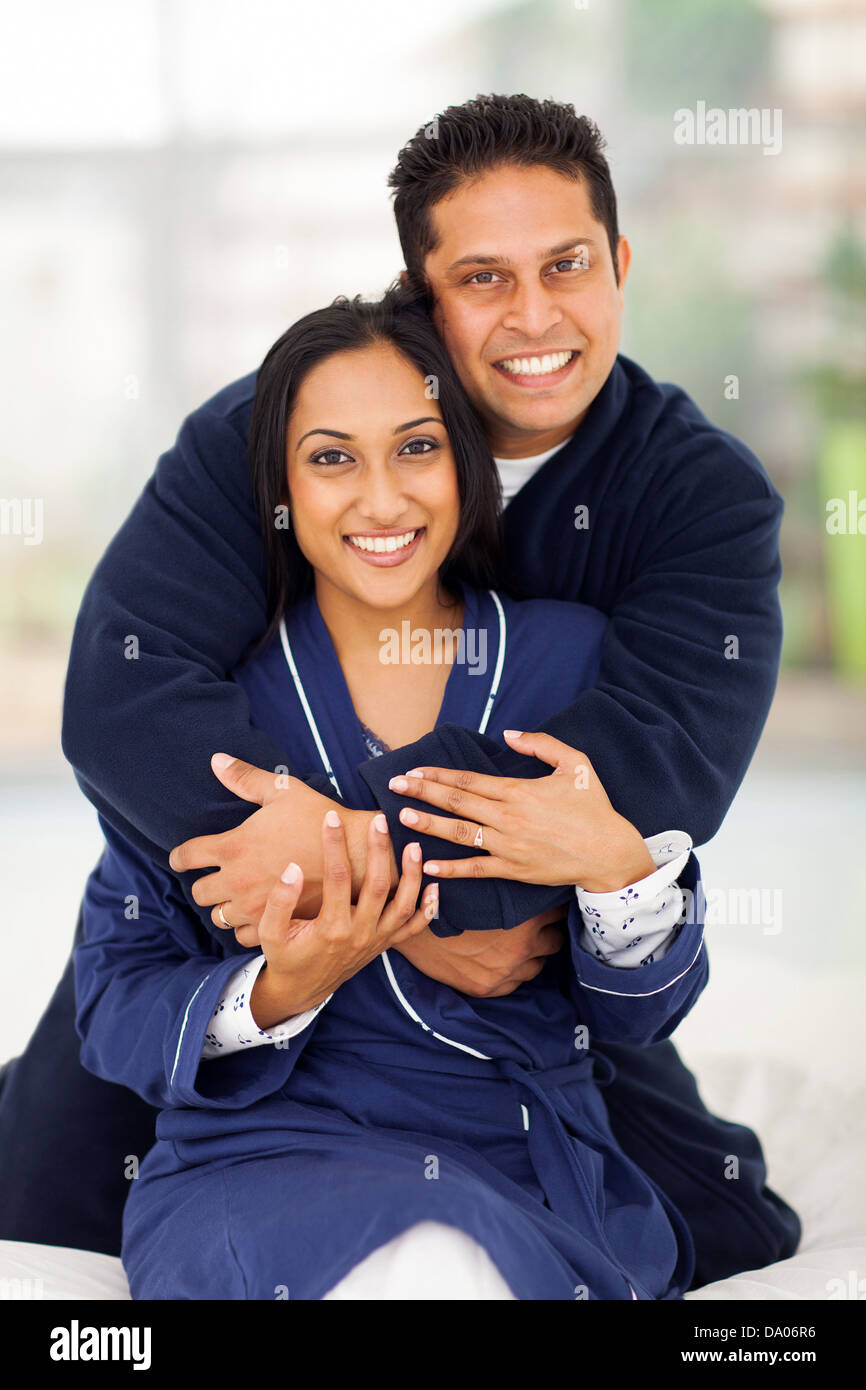happy indian couple hugging on bed at home Stock Photo - Alamy