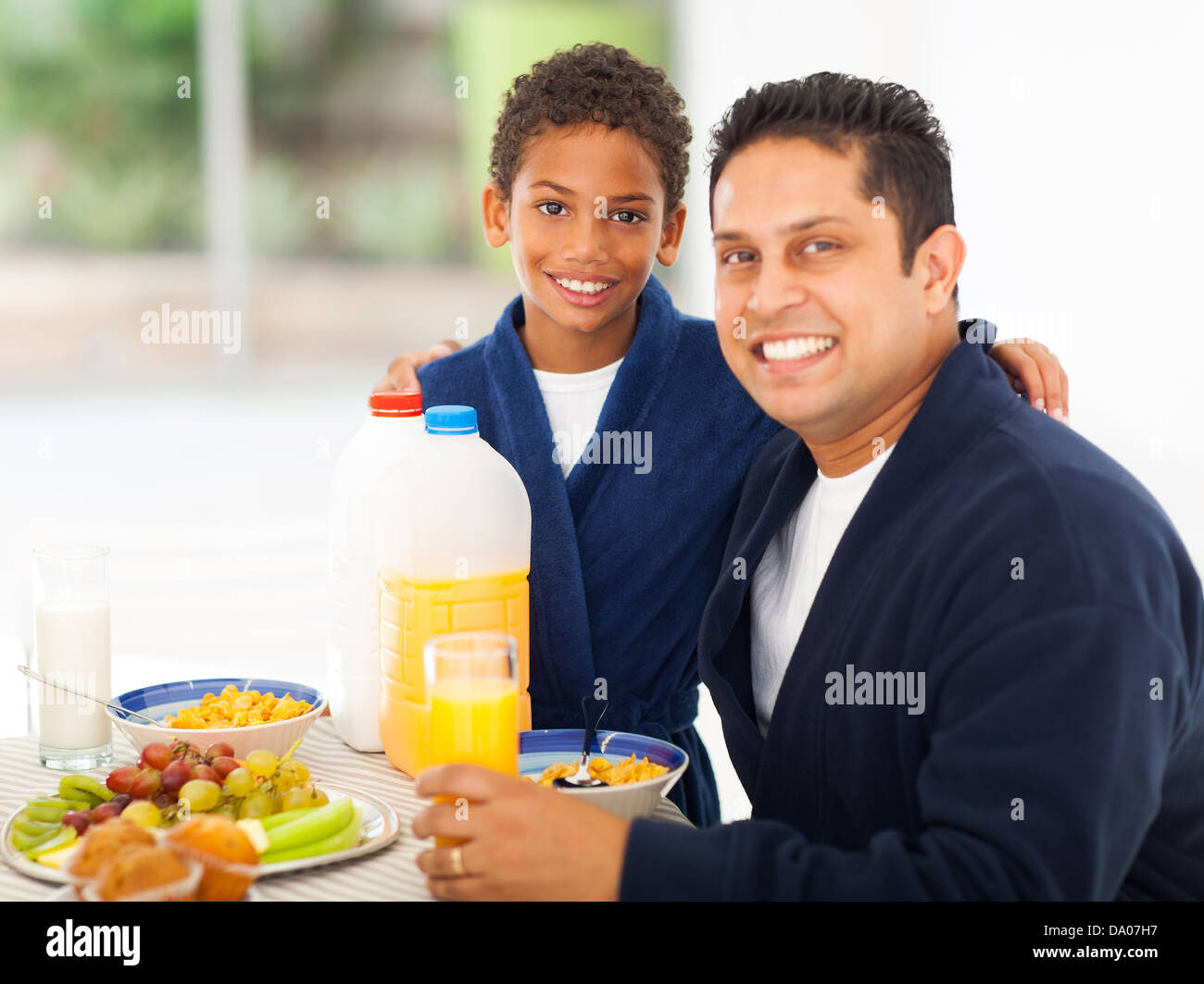 cheerful indian father and son at breakfast table Stock Photo - Alamy