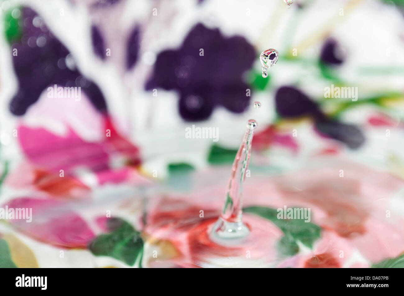 drop of water splashing on a colorful background Stock Photo - Alamy