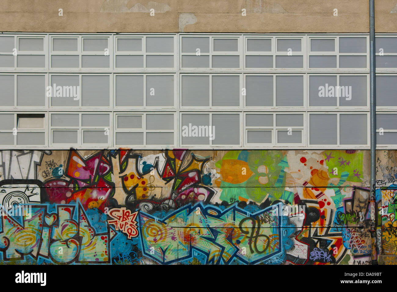 Colourfull graffiti on the wall under the huge window Stock Photo - Alamy