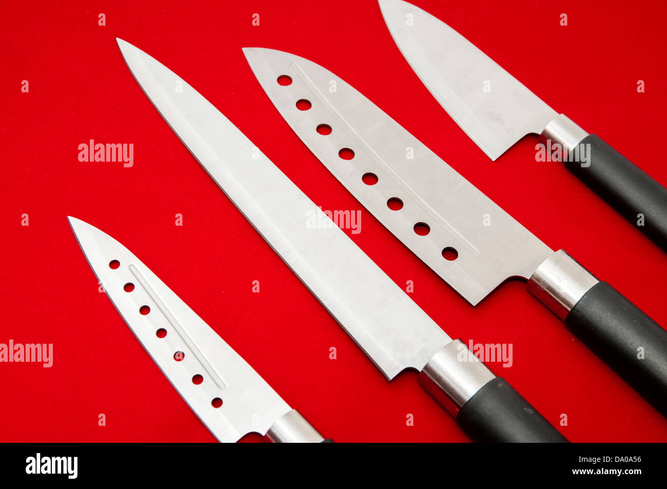 kitchen knives on a red background Stock Photo - Alamy