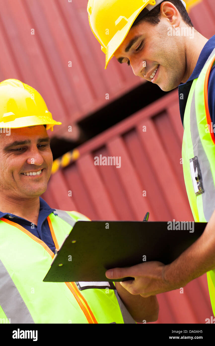 smiling harbor workers recording containers before exporting Stock ...