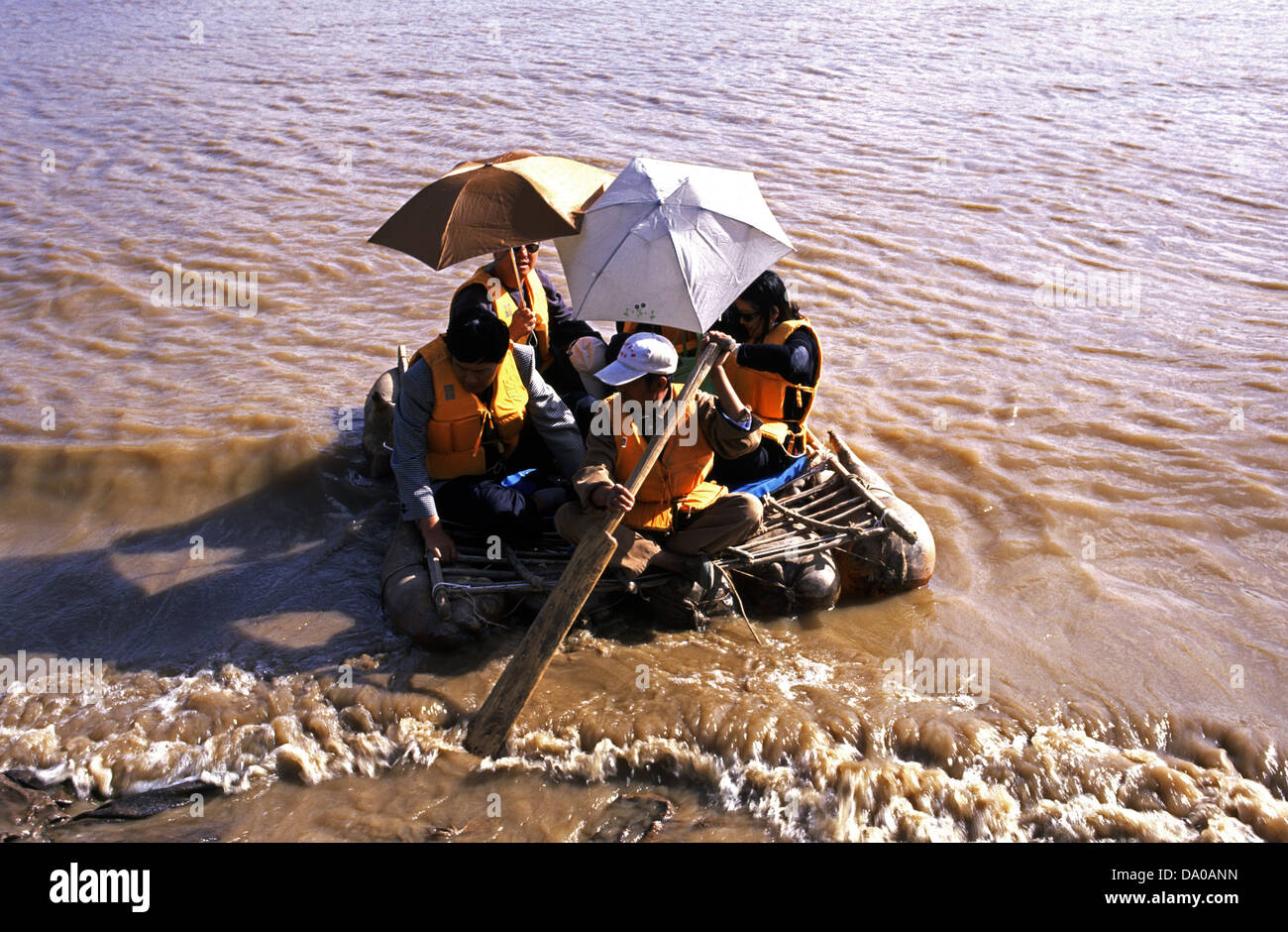 Chinese men rowing in a raft made from inflated sheepskin lashed to a ...