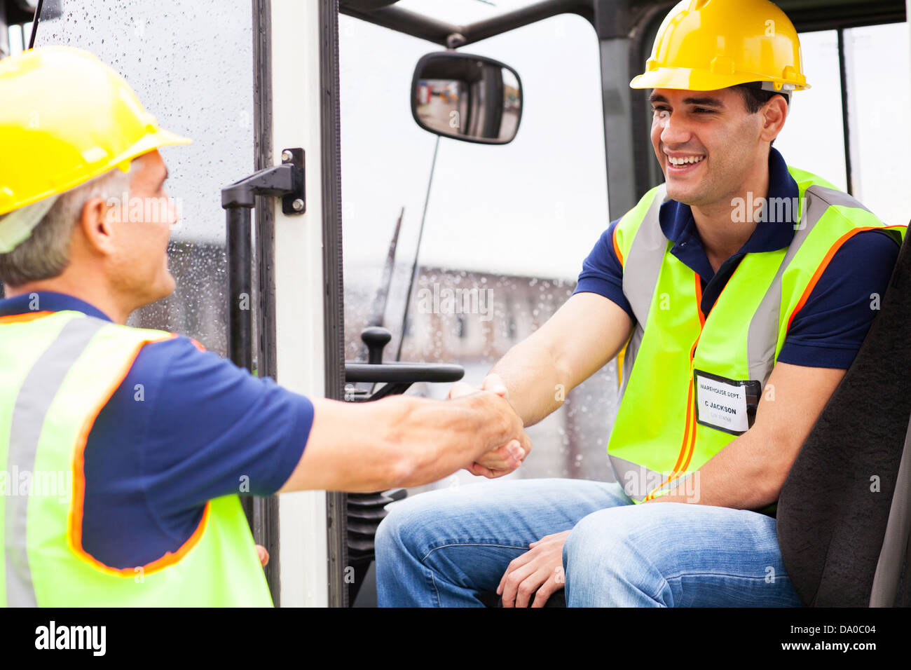 two warehouse forklift drivers handshaking when shift change over Stock ...