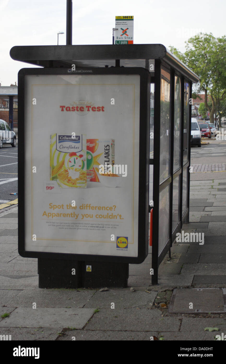Bus stop, Adverising at front, Cars parked behind, pavement, road Stock ...