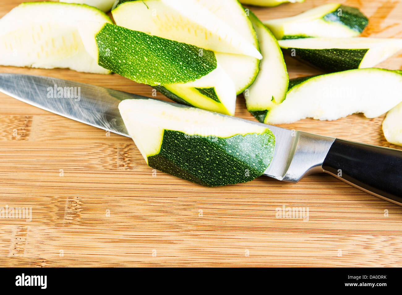 Horizontal photo of a large knife and sliced pieces of zucchini on ...