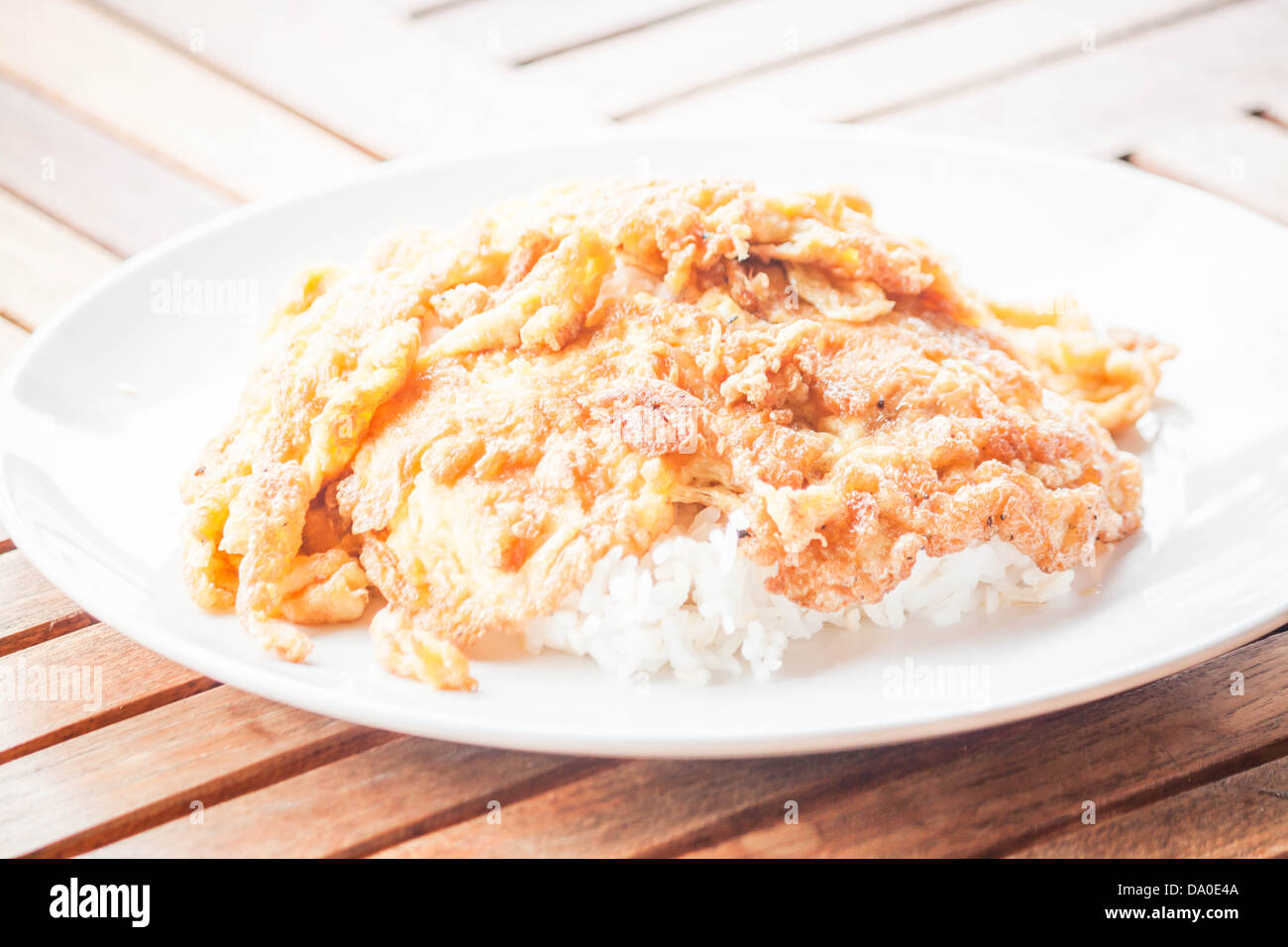 Plain egg omelet top on cooked rice Stock Photo - Alamy