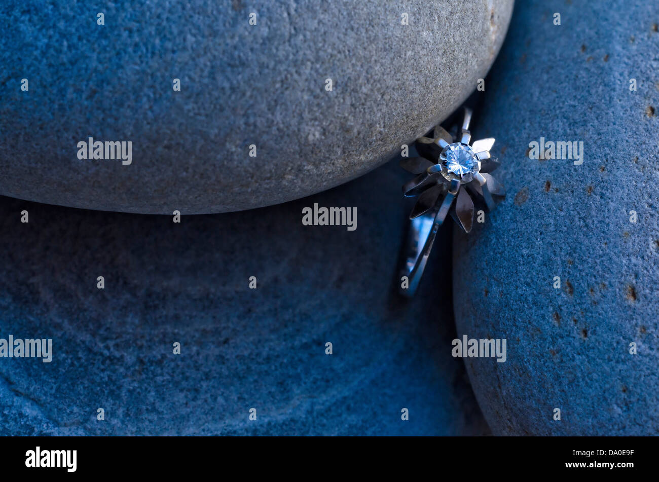 A diamond ring on three pebbles Stock Photo - Alamy