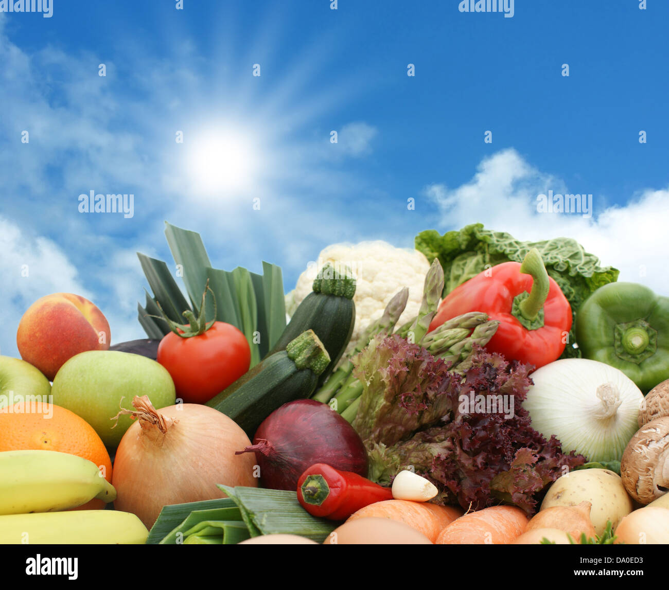 A mixture of fruits and vegetables against a sunny blue sky Stock Photo ...