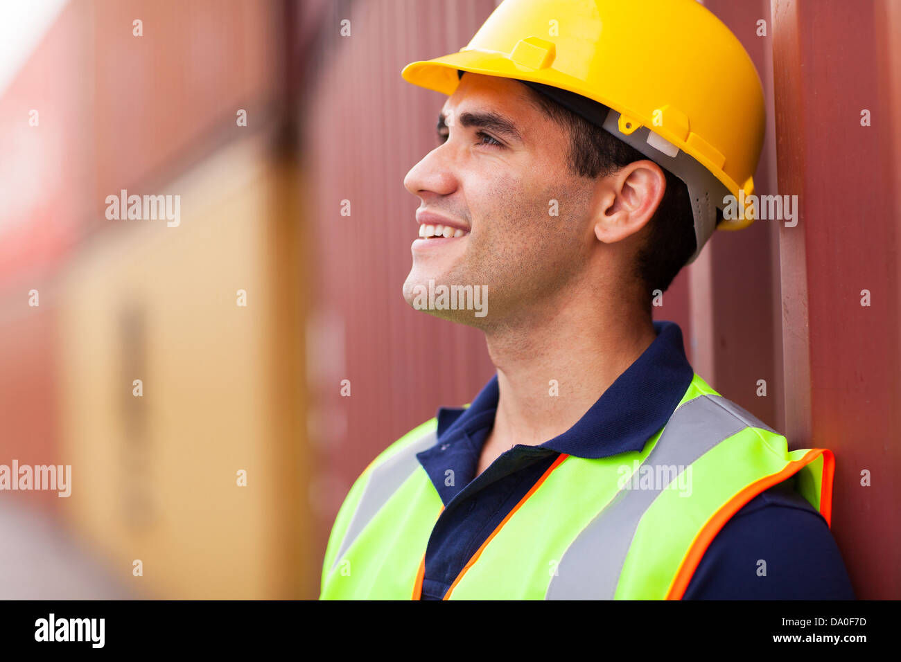 optimistic young harbor worker in container yard Stock Photo - Alamy