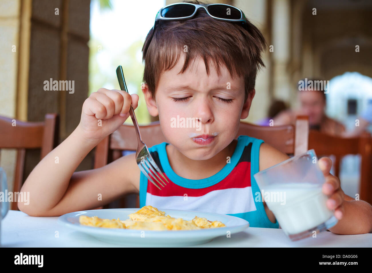 Cute little boy having delicious breakfast Stock Photo - Alamy