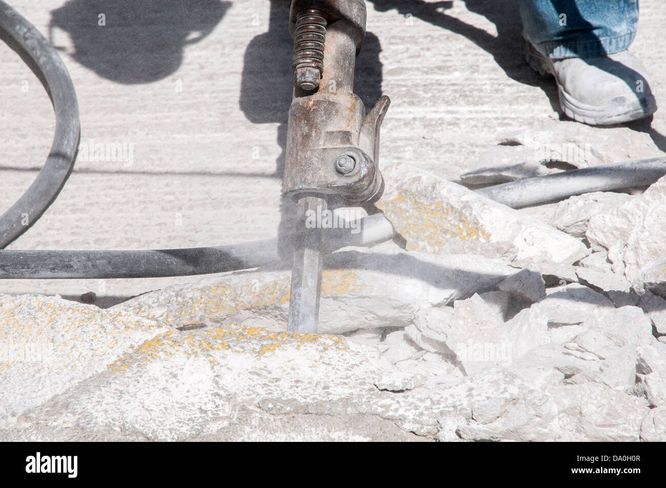 working man breaking the ground with a machine Stock Photo - Alamy