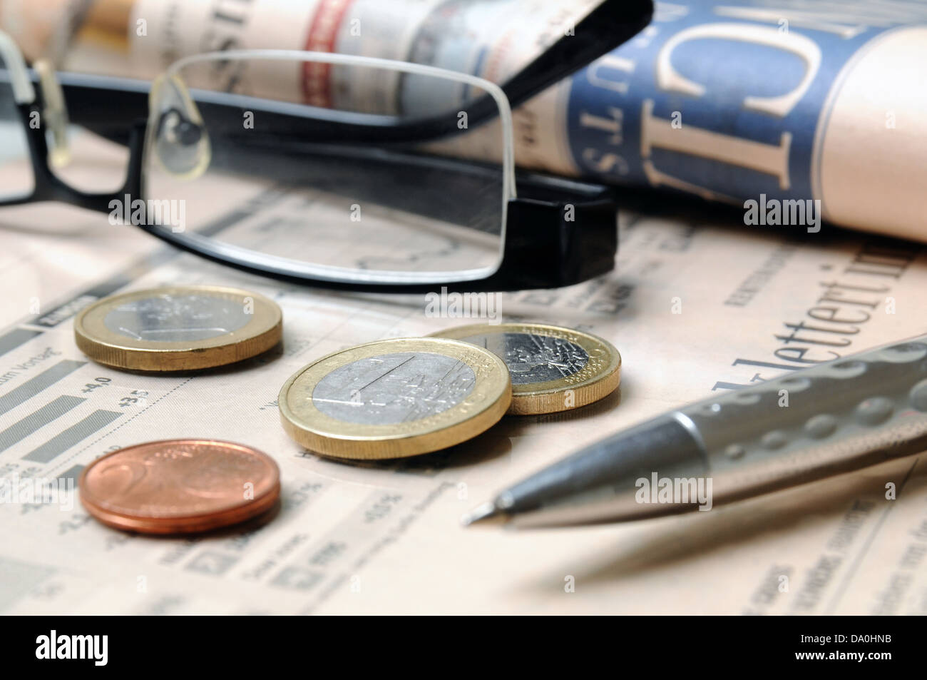 Euro money coins, glasses and ball pen on a financial report Stock ...