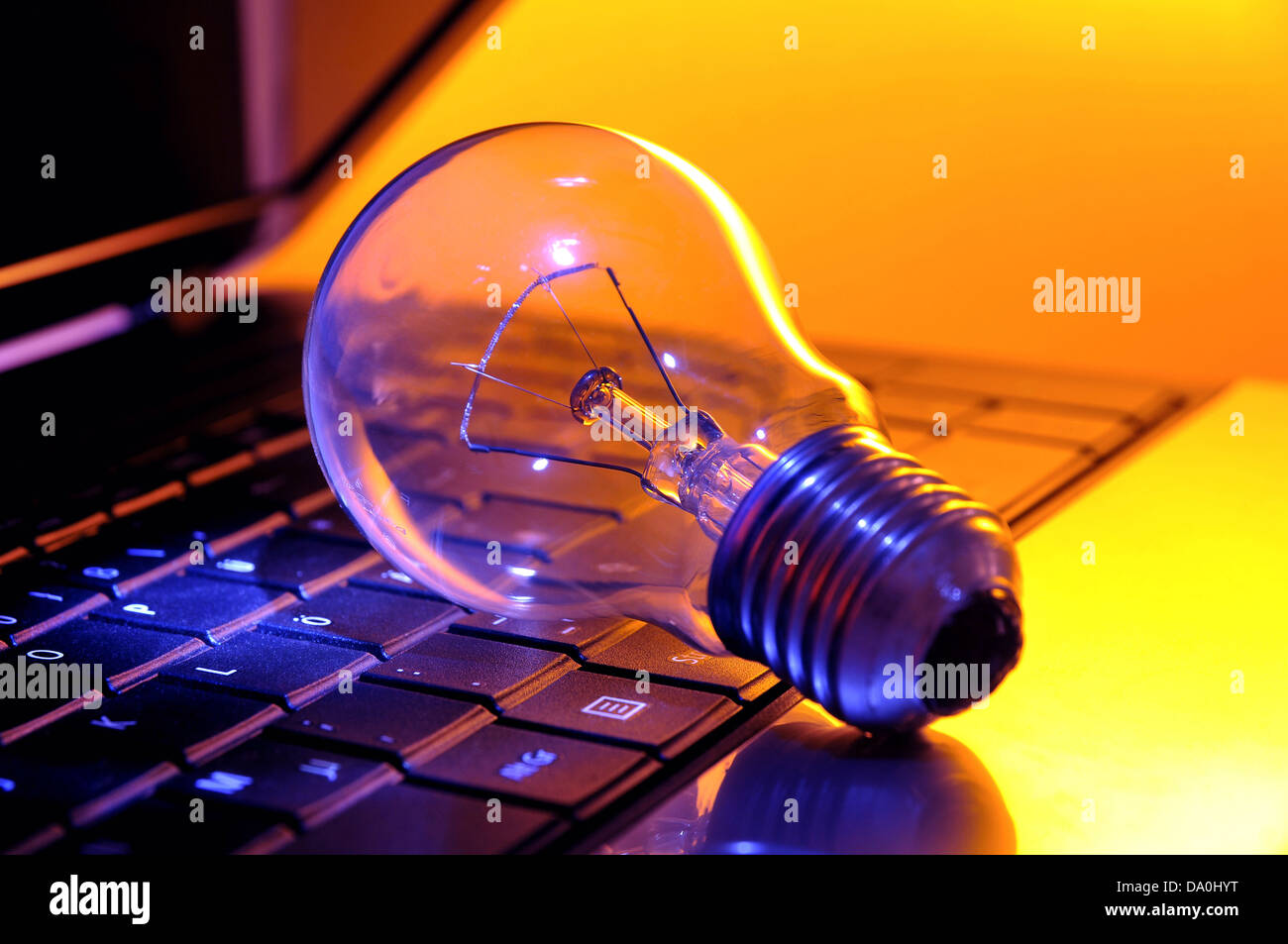 Light bulb on a laptop keypad with rainbow colors Stock Photo - Alamy