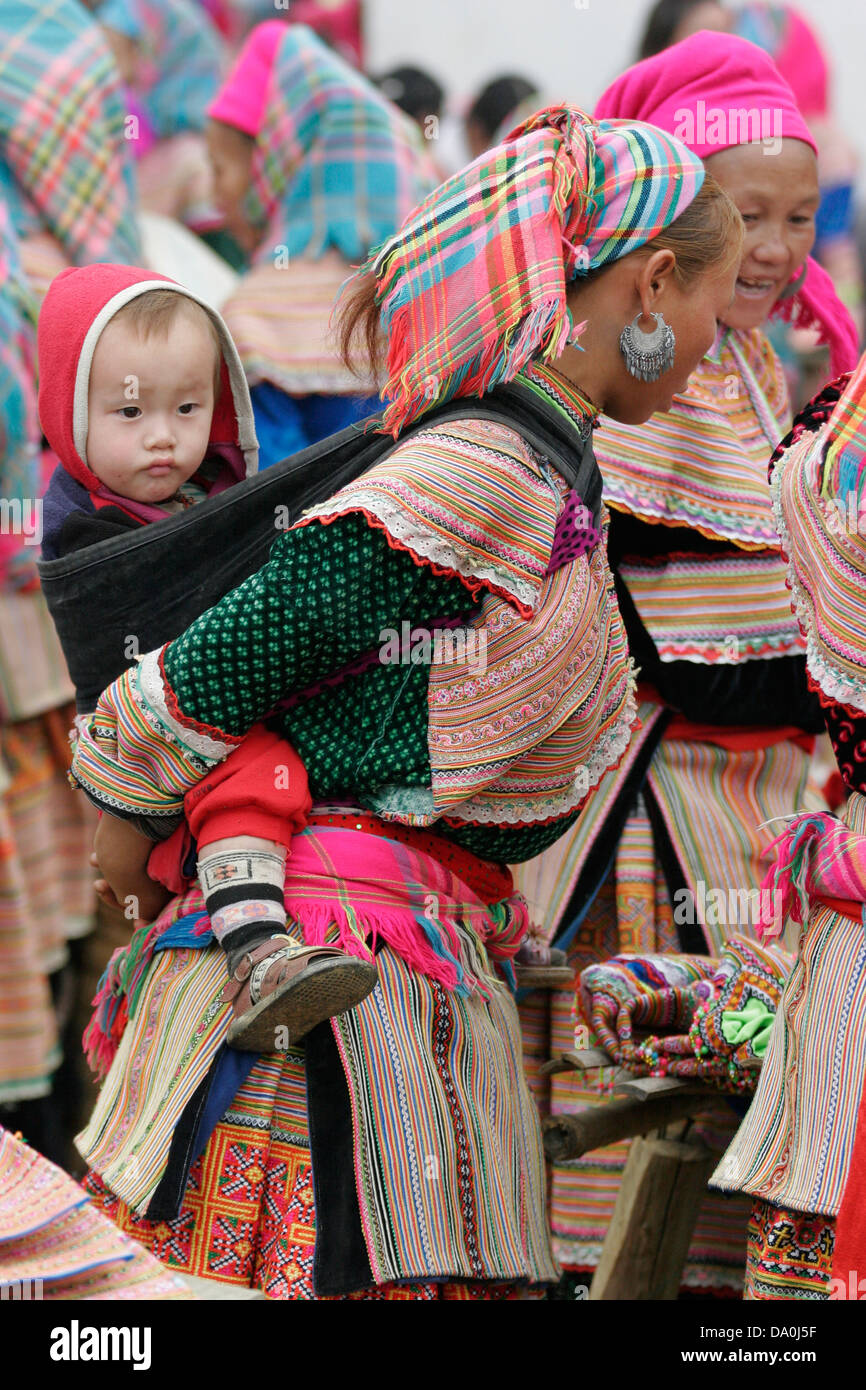 Flower Hmong woman with her child on the back at the market in Bac Ha ...