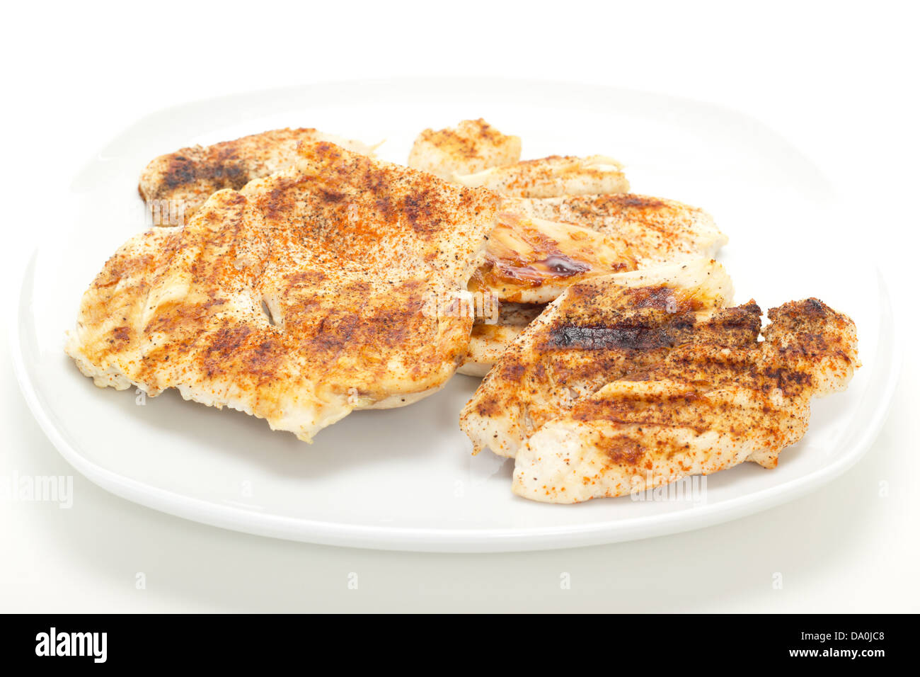 Delicious spiced chicken on white plate Stock Photo - Alamy