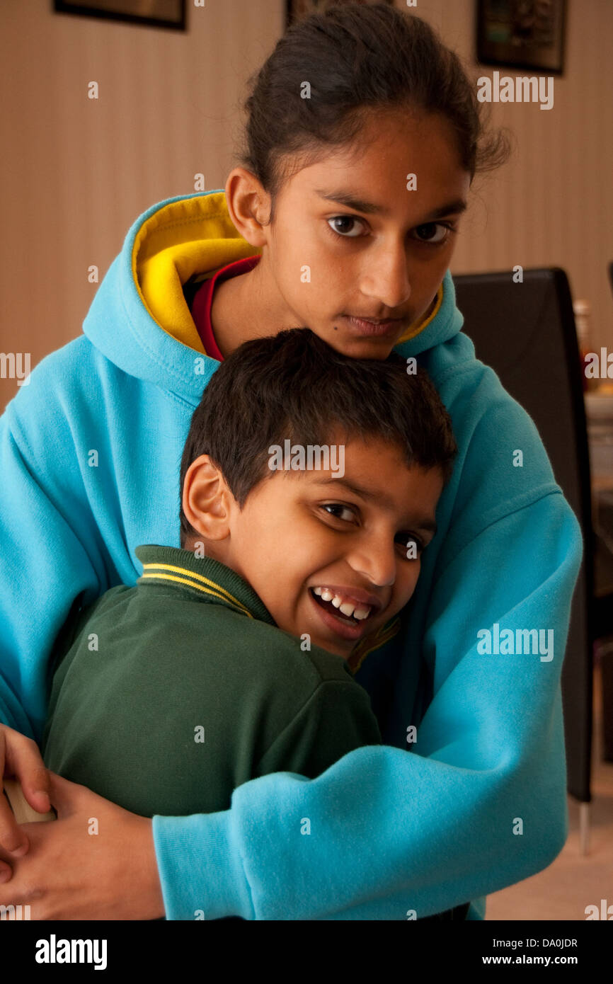 Brother and Sister cuddling Stock Photo - Alamy