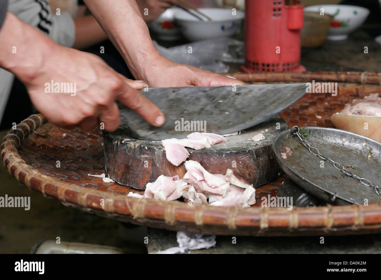 Flower Hmong man cutting meat at the market in Bac Ha, Vietnam ...