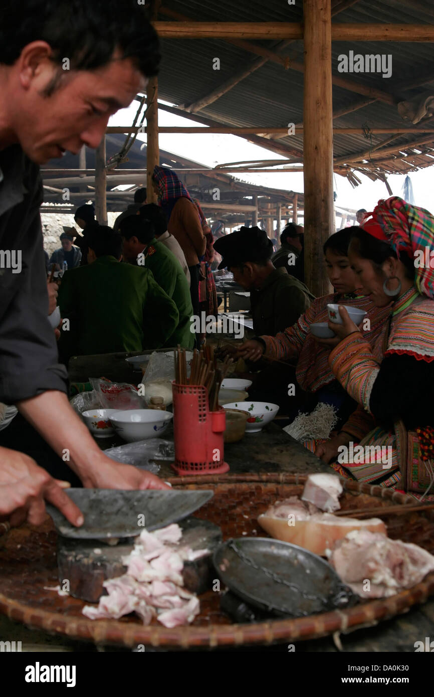 Flower Hmong women eating traditional tribal food at the market in Bac ...