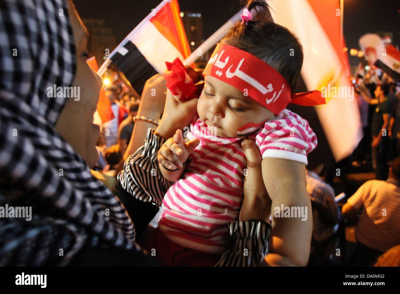 Cairo, Egypt. 28th June, 2013. An Egyptian mother holds her baby in her ...