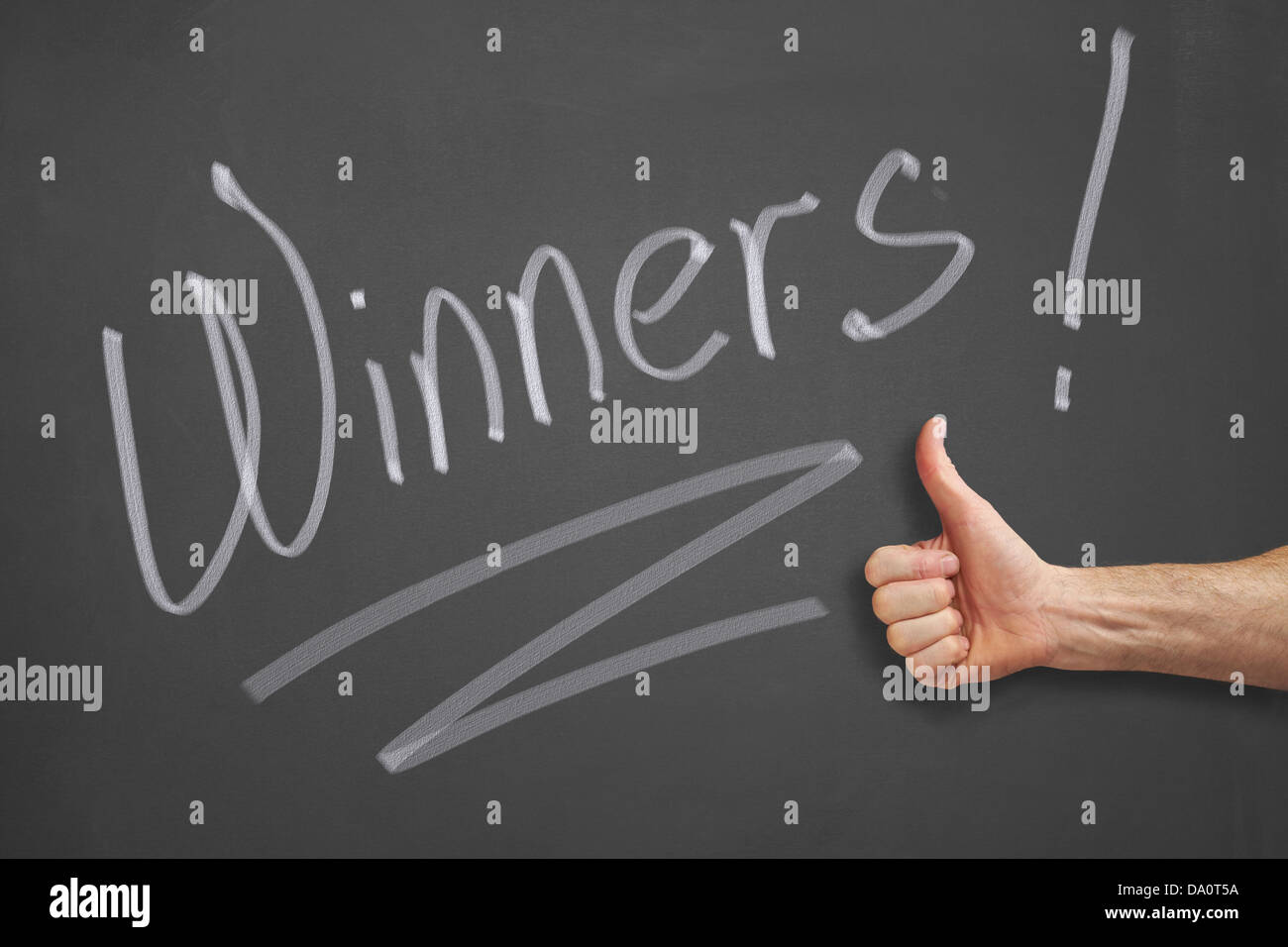 Mans hand with a thumbs up in front of a winners message on a ...
