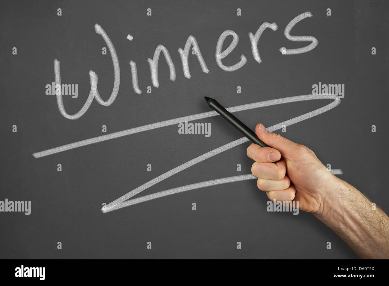 Mans hand pointing to a winners message on a chalkboard Stock Photo - Alamy