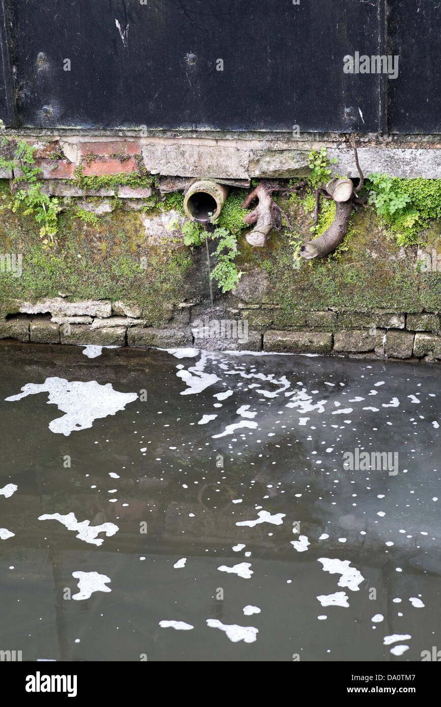 Drain pipe discharging into river Stock Photo - Alamy
