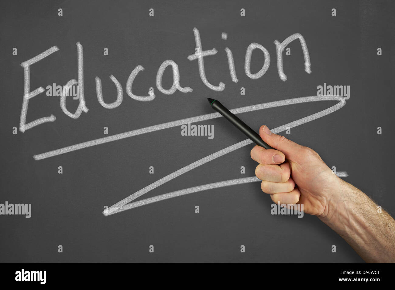 Mans hand pointing to a education message on a chalkboard Stock Photo ...