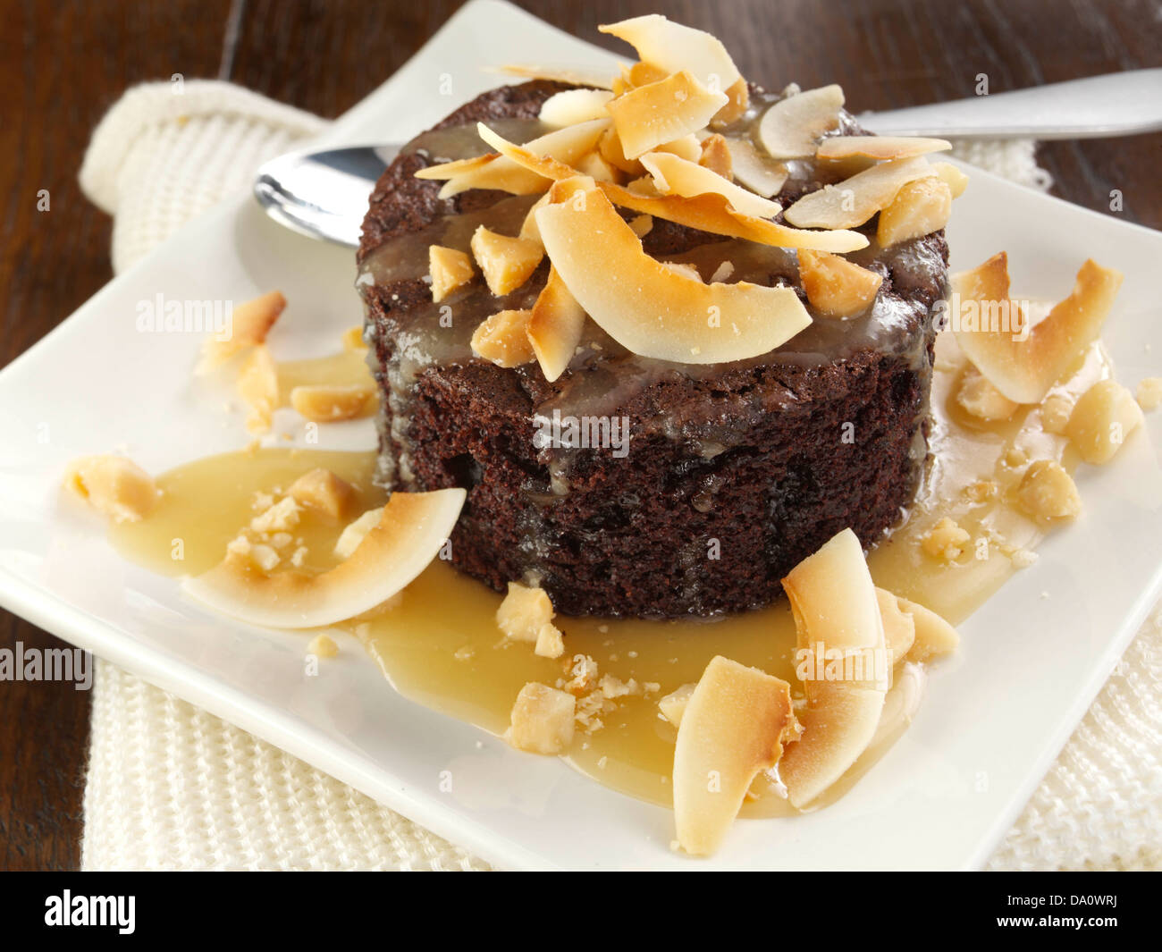 Chockablock chocolate cakes with warm Macadamia nut caramel Stock Photo ...