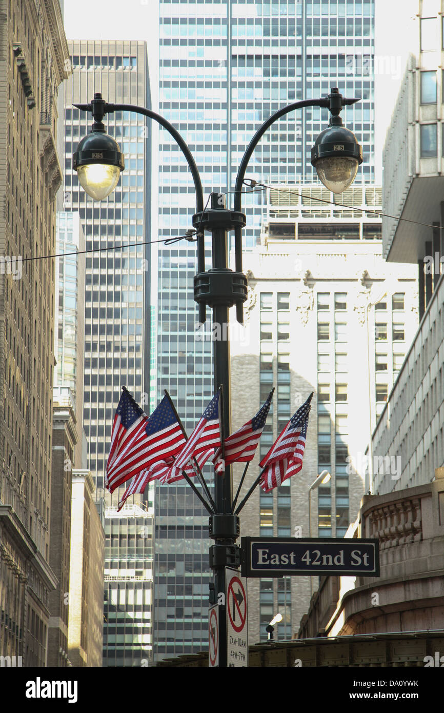 New York, June 24 2013. A set of flags flap by a lamp post next to the ...