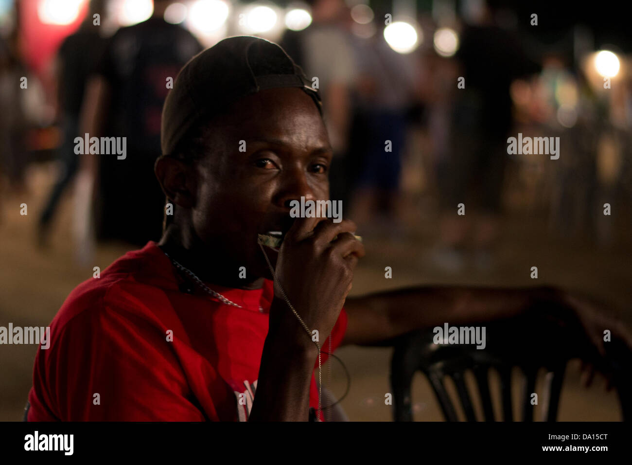 African man playing harmonica Stock Photo - Alamy