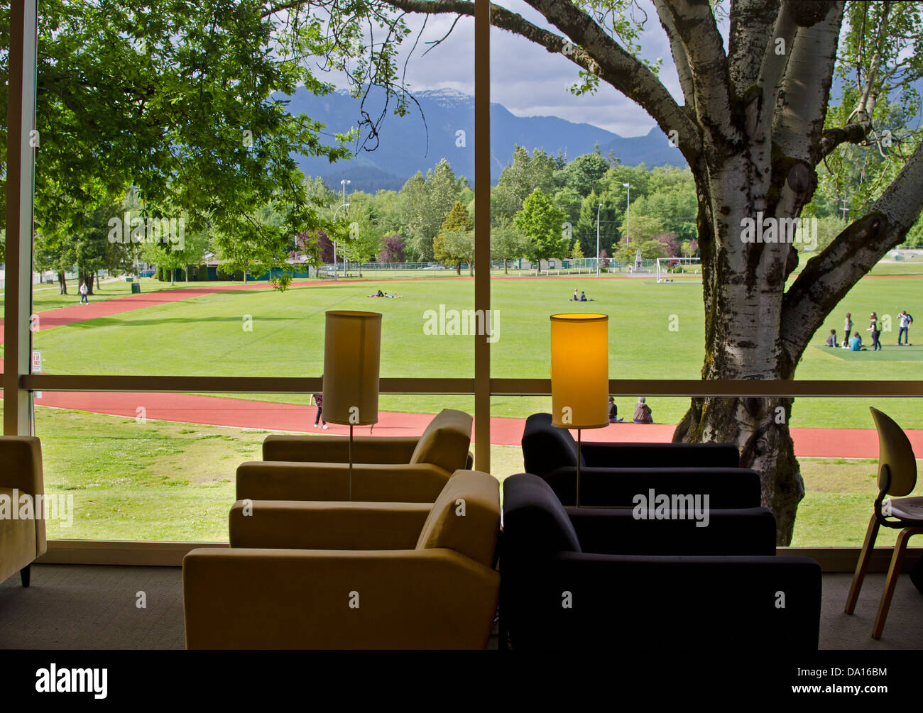 Chairs and lamps of the Burnaby Public Library with a window view of a ...