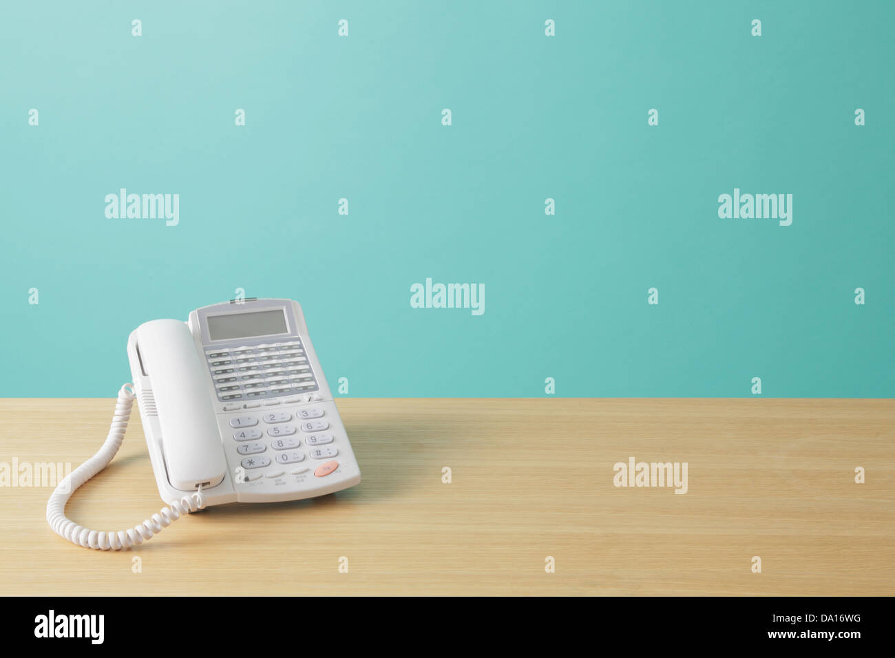 Telephone on wooden desk Stock Photo - Alamy
