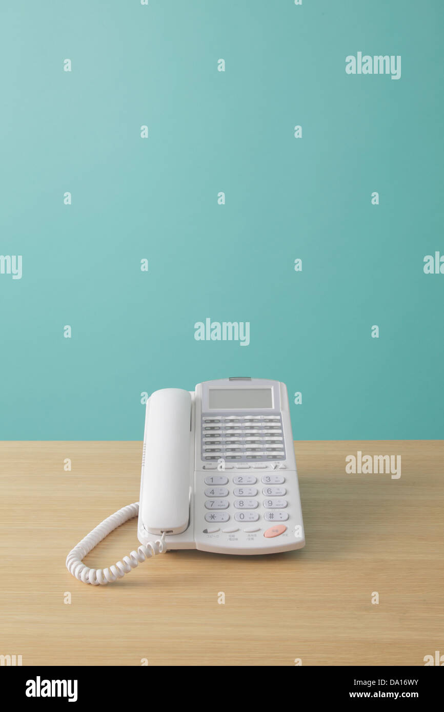 Telephone on wooden desk Stock Photo - Alamy